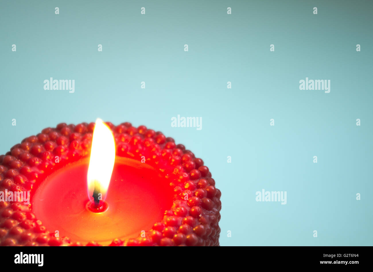 Candlelit background. Red candle closeup Stock Photo - Alamy