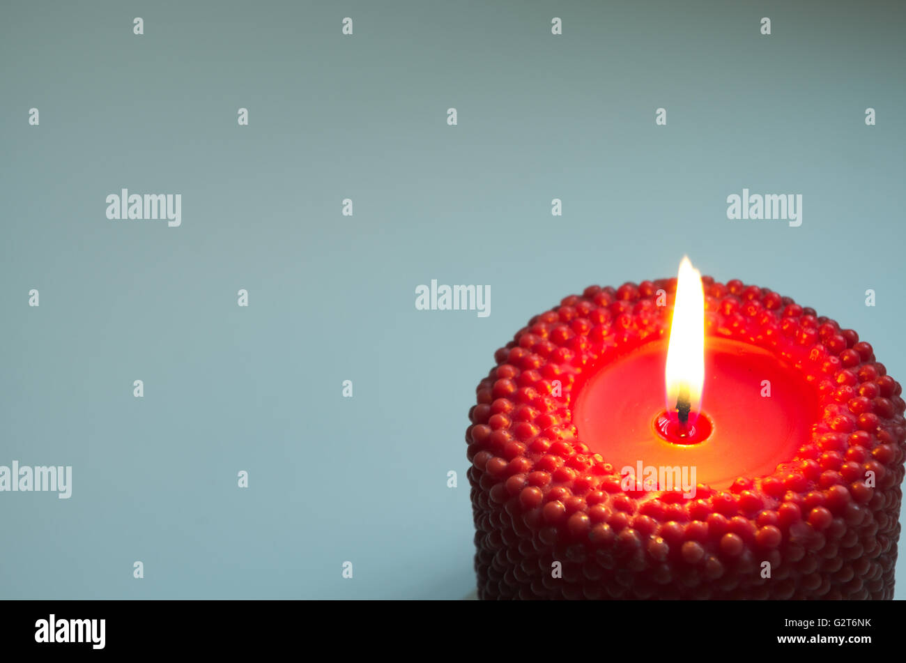 Candlelit background. Red candle closeup Stock Photo - Alamy
