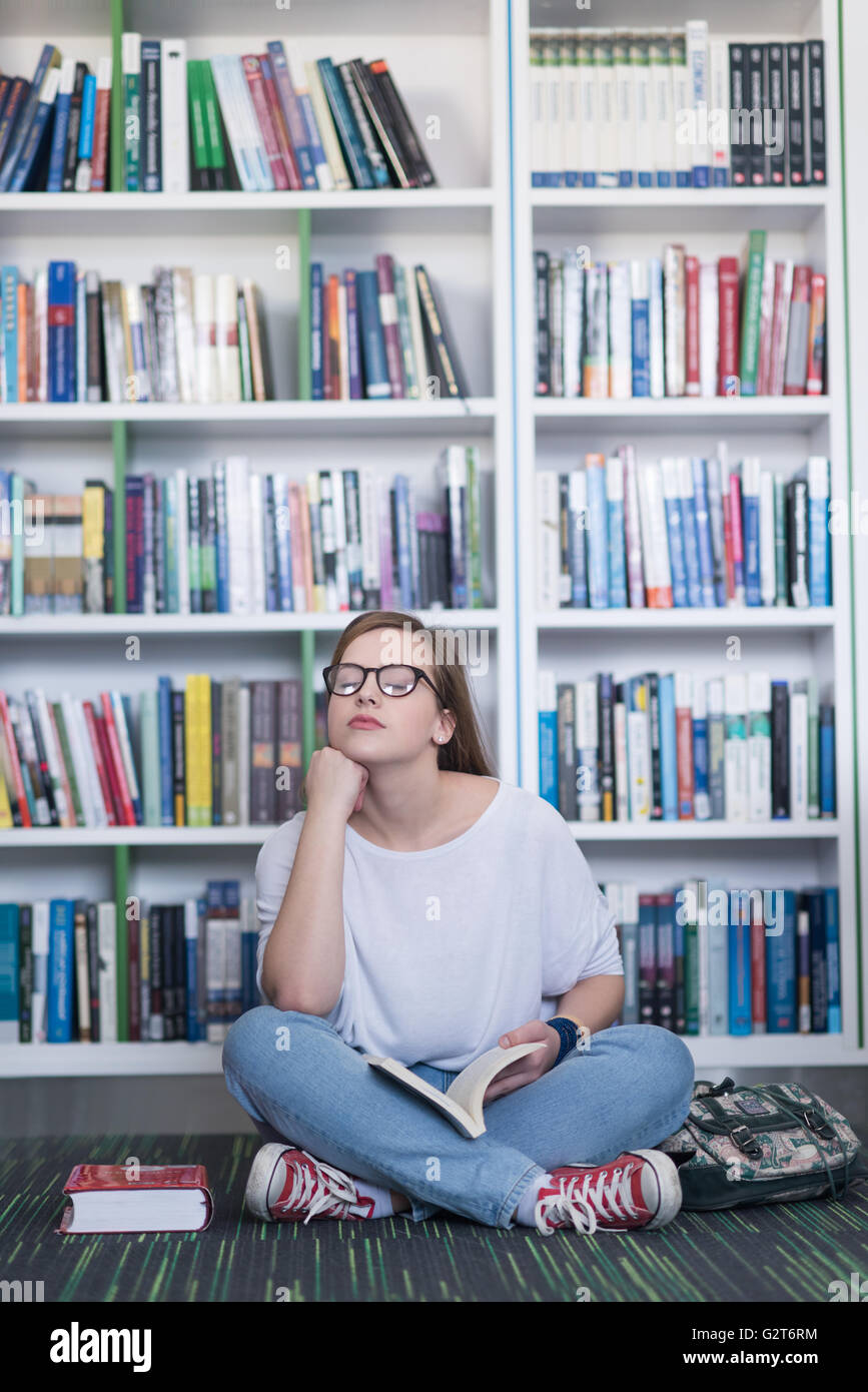 smart looking famale student girl in collage school library reading ...