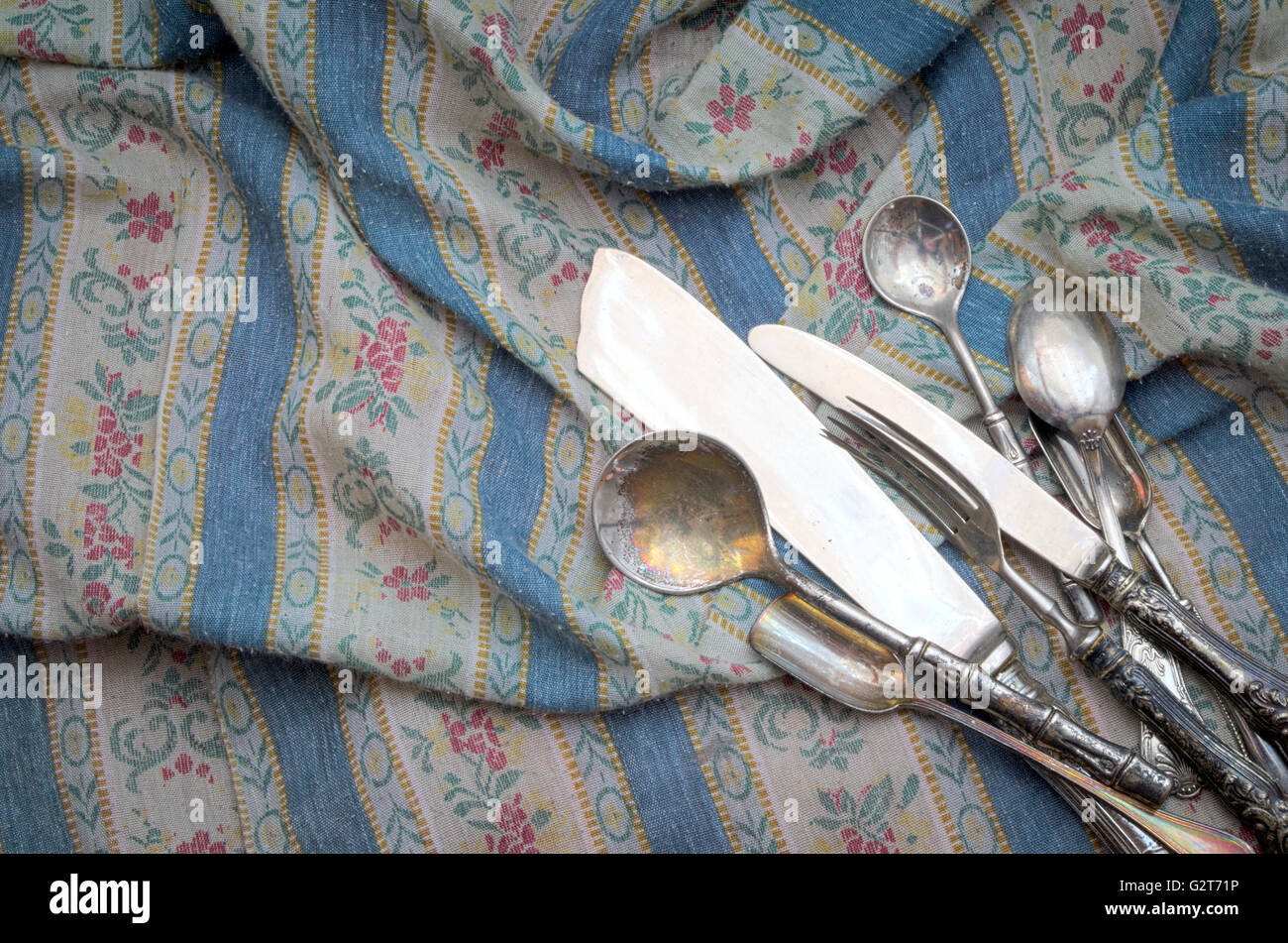 Vintage silverware on classic old fabric. Classic background Stock ...