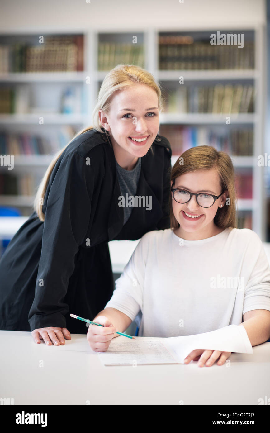 female teacher helping students on class about lessons and give support ...