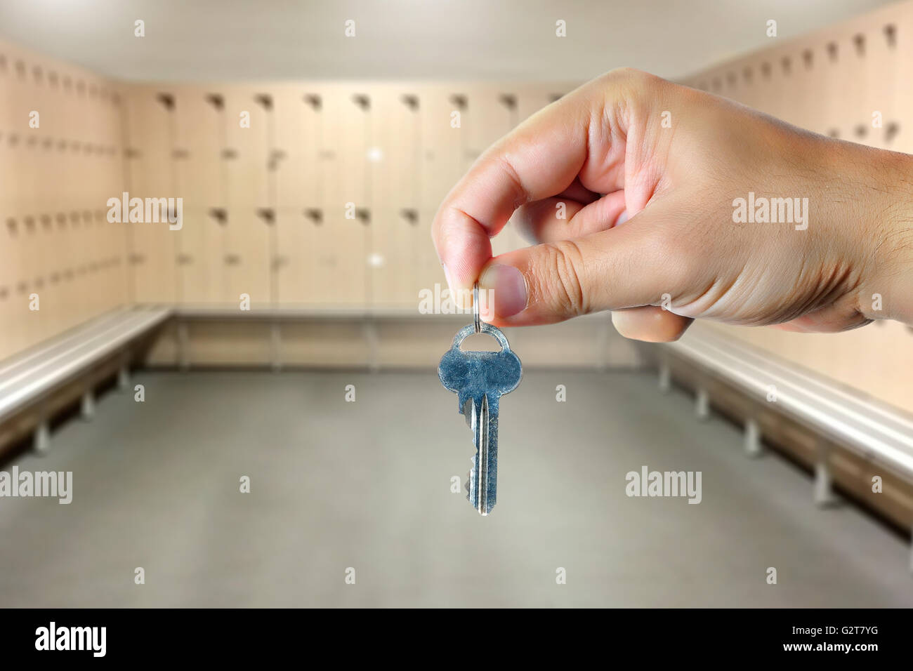 Male hand holding a key in an empty locker room Stock Photo - Alamy