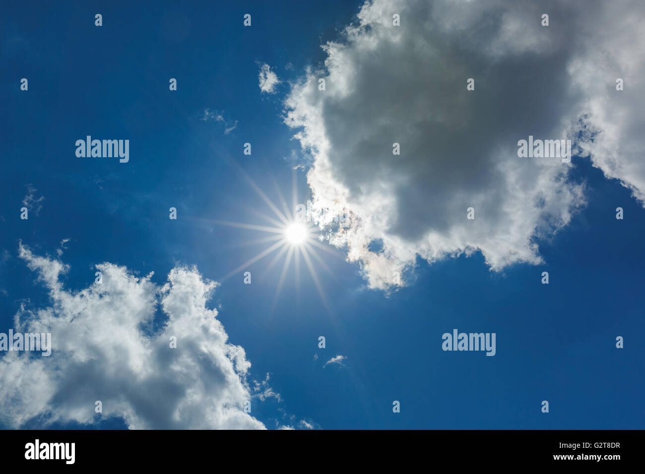 Blue cloudy sky. Dramatic blue sky with clouds and Sun. rays of light ...