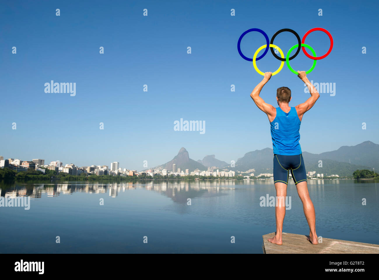 RIO DE JANEIRO - MARCH 27, 2016: Athlete holding Olympic rings stands ...