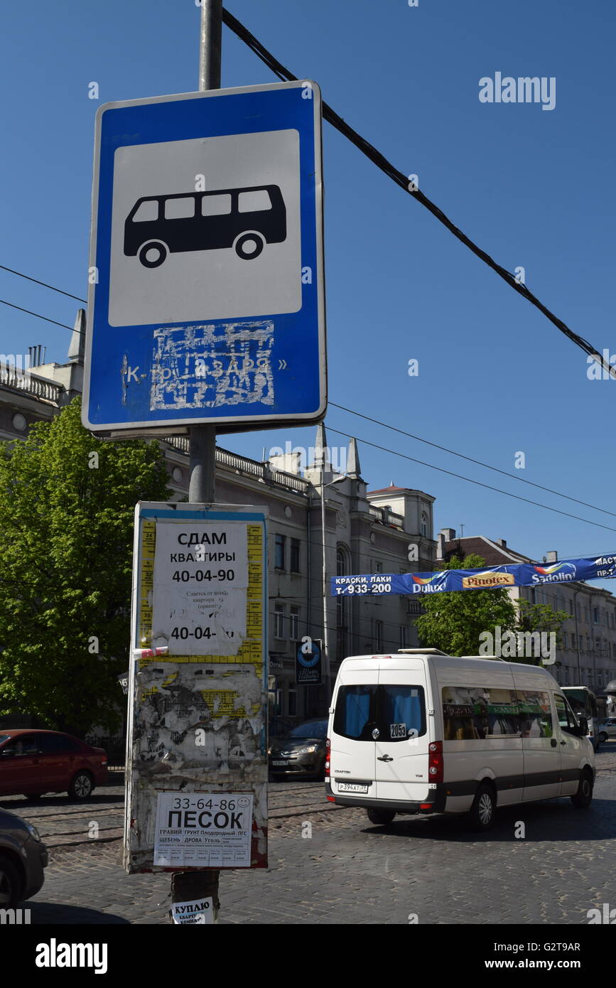 Urban bus service in Kaliningrad city. Bus stop sign with remainders of ...