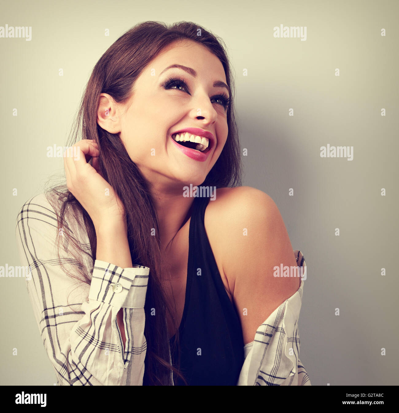 Happy casual toothy laughing woman in shirt looking up. Toned vintage ...