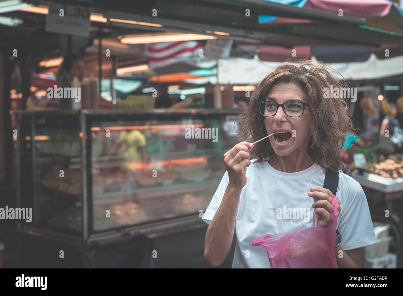 Street food in Kuala Lumpur, Malaysia. Traveling woman eating ...