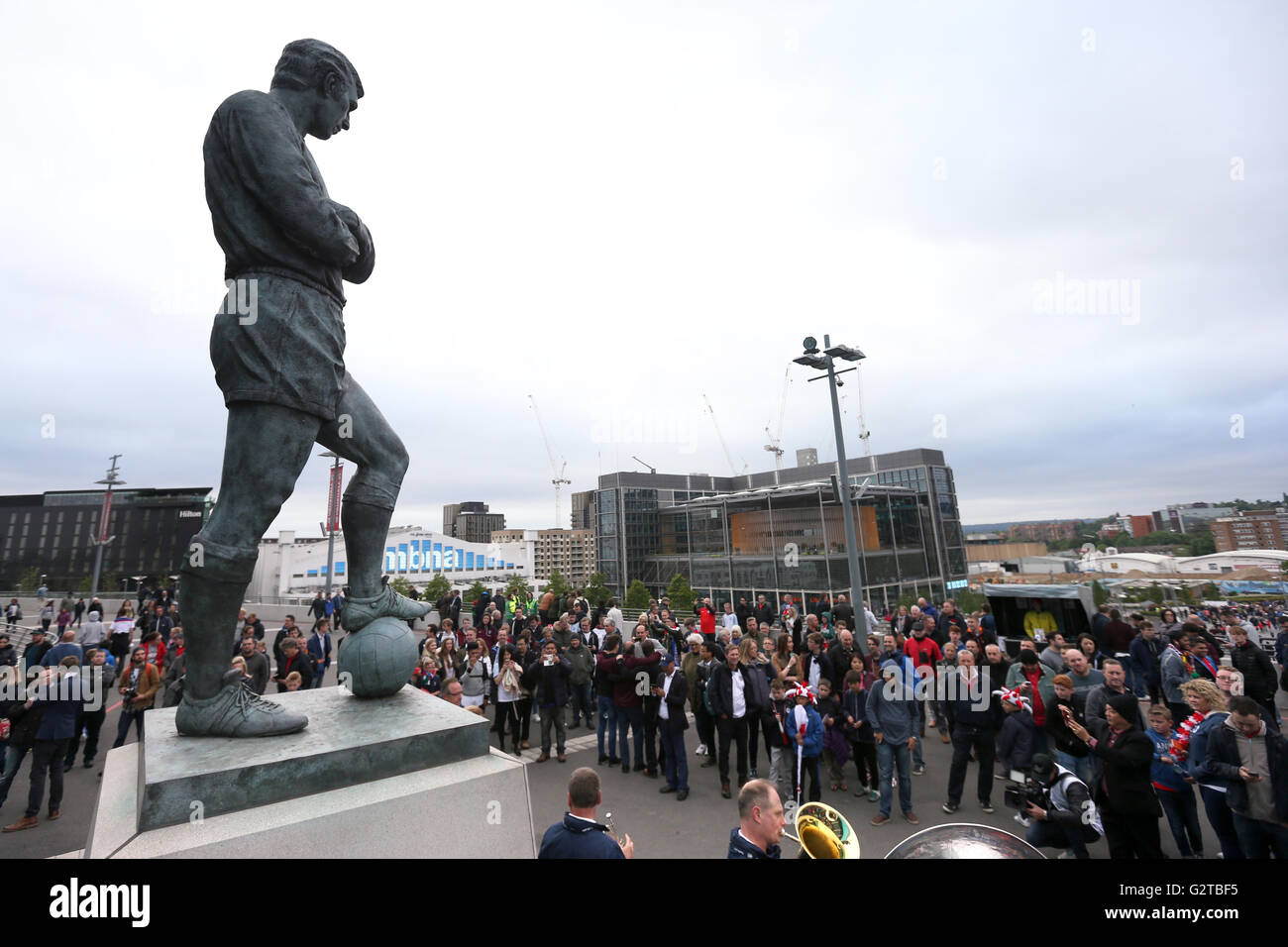 Fans gather in front of the Bobby Moore statue outside Wembley Stadium ...