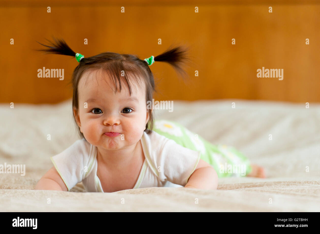 Baby tummy time with funny facial expression Stock Photo - Alamy