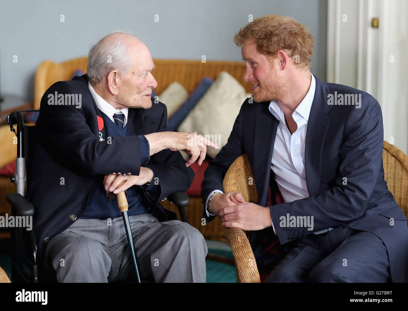 Prince Harry speaks to Anthony Colgan, 92, during a reception with ...