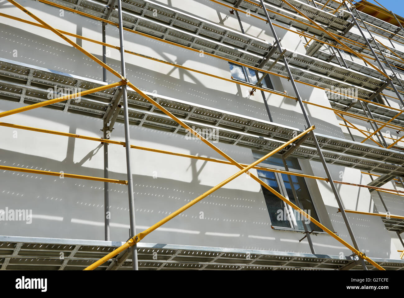 scaffolding near a house under construction for external plaster works ...