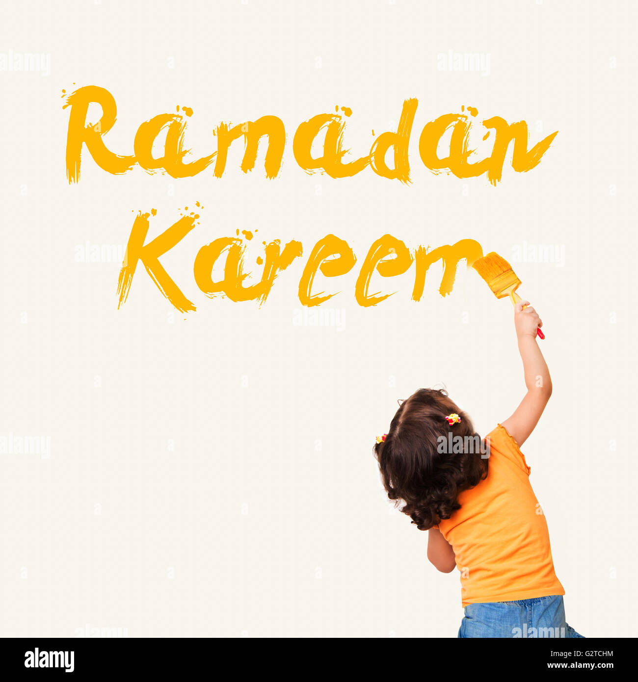 Cute little Muslim girl drawing Ramadan Kareem with painting brush ...