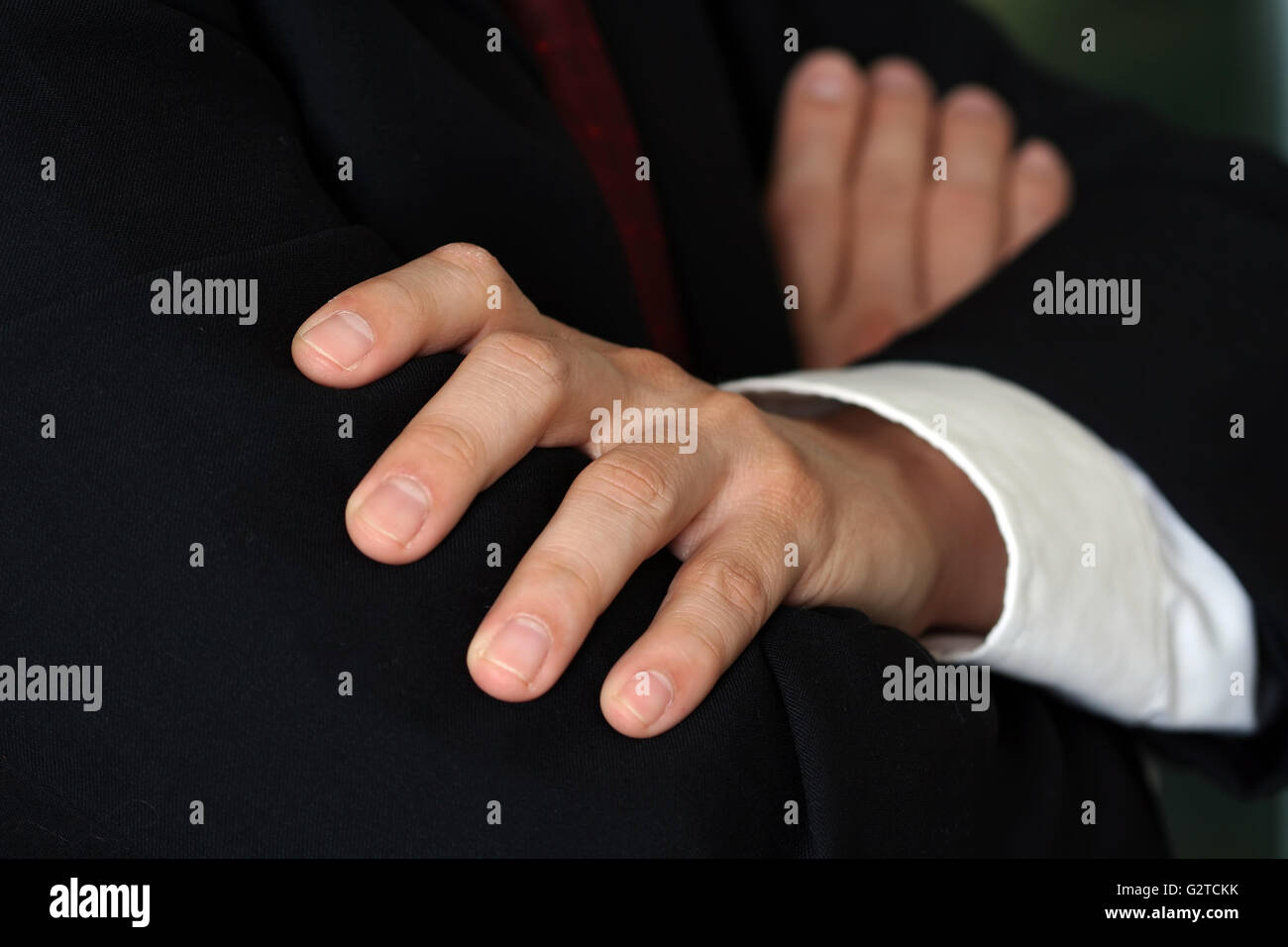 Businessman folding hands Stock Photo - Alamy
