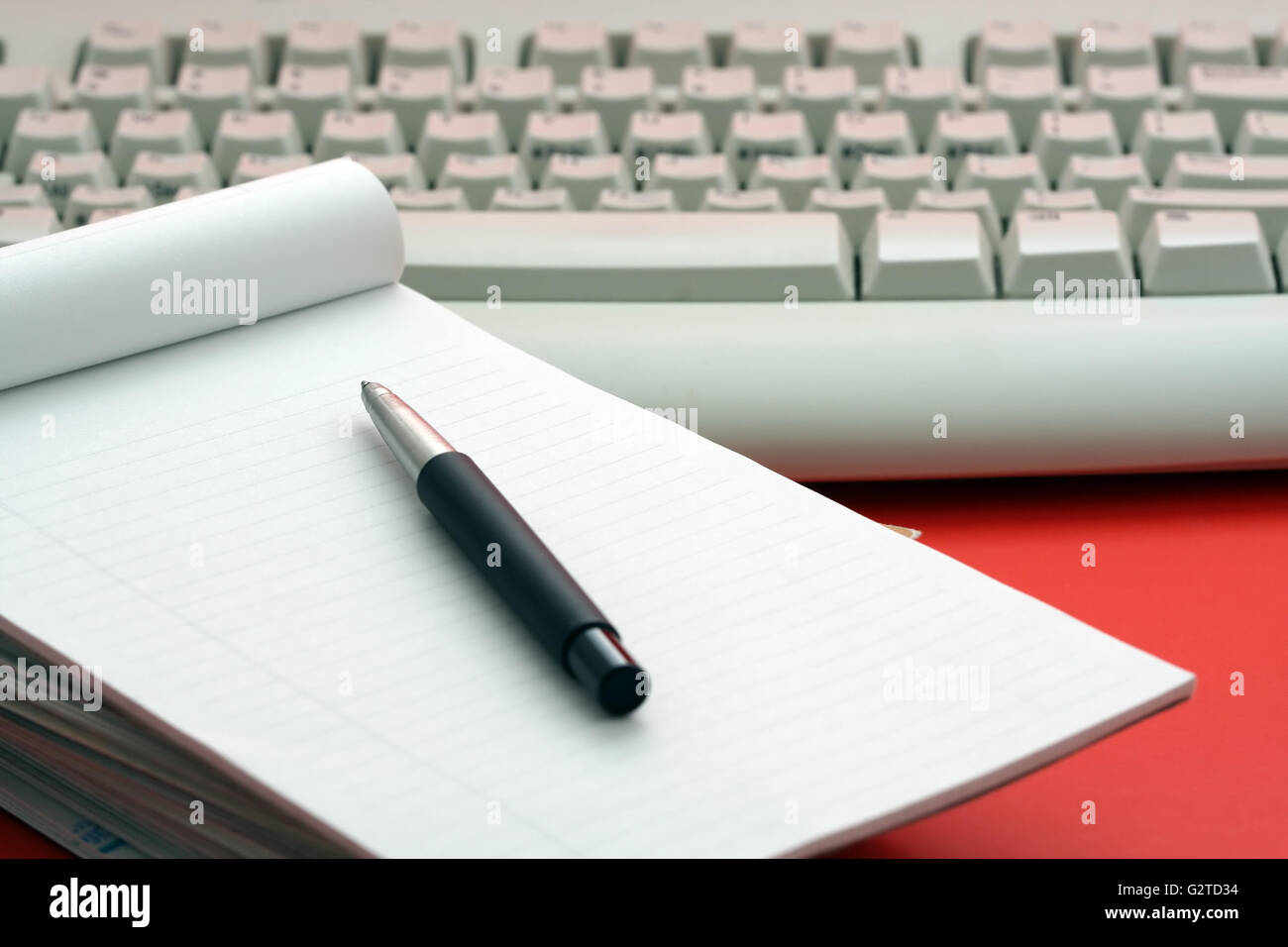 Stack of paper and keyboard, symbolizes communication Stock Photo - Alamy