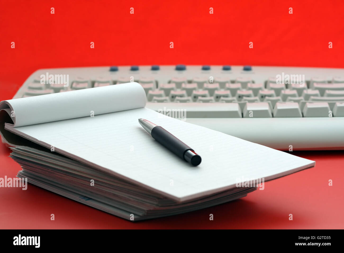 Stack of paper and keyboard, symbolizes communication Stock Photo - Alamy