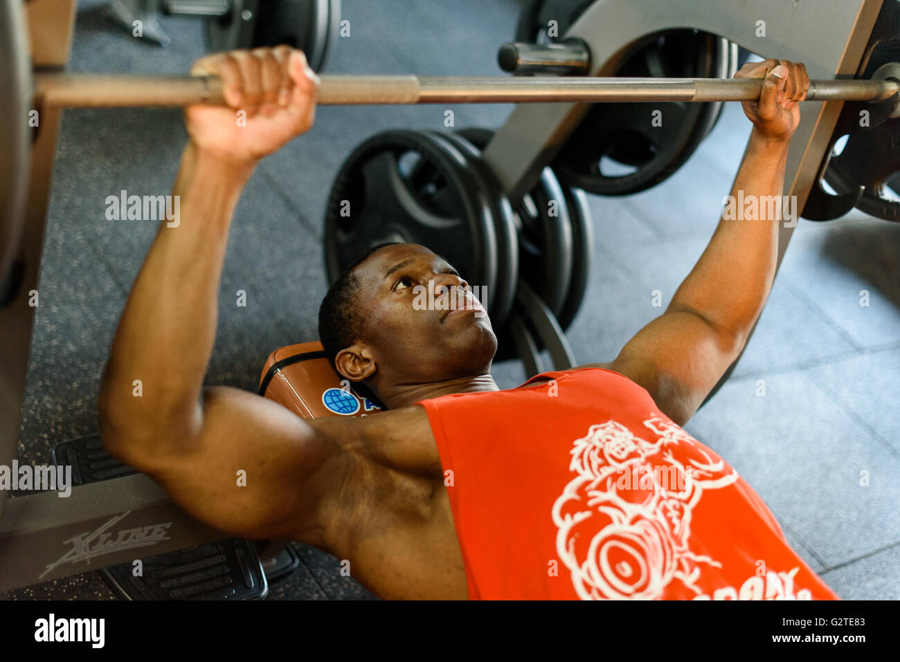 Portrait of black african-american bodybuilder training with barbell in ...