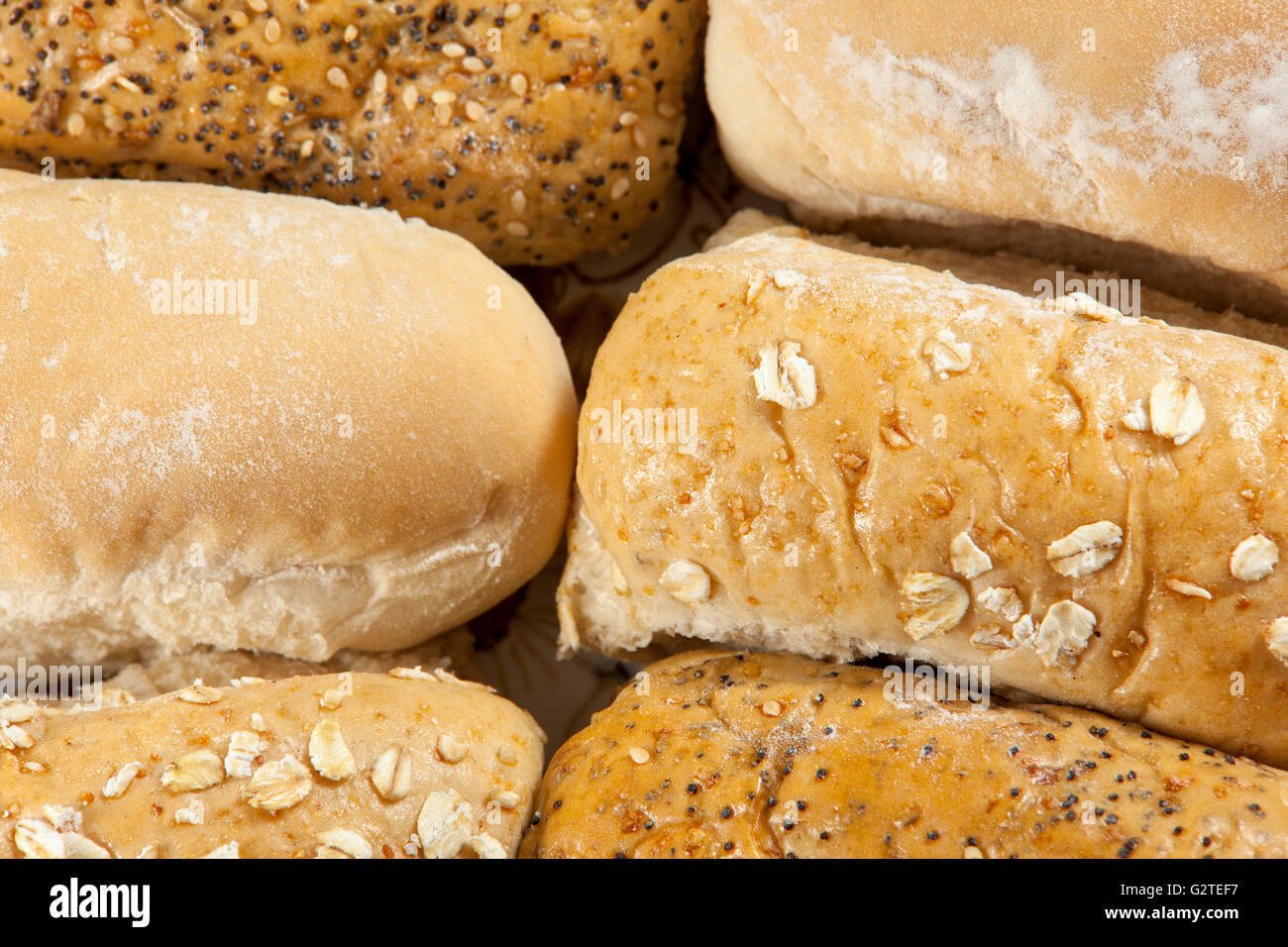 Close up shot of various types of bread finger rolls laying on a plate ...