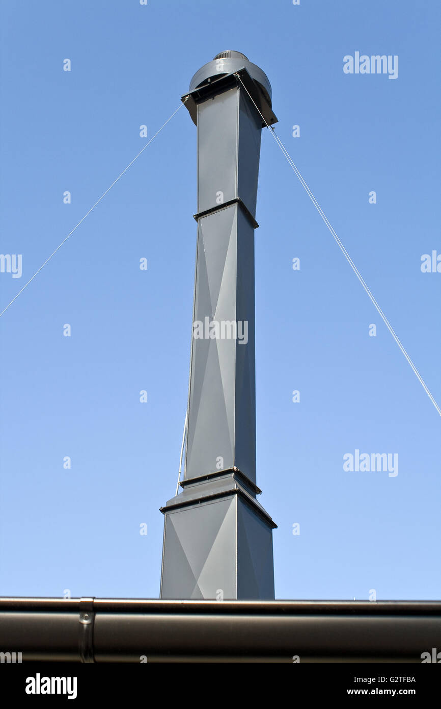 Kitchen chimney over blue sky Stock Photo - Alamy