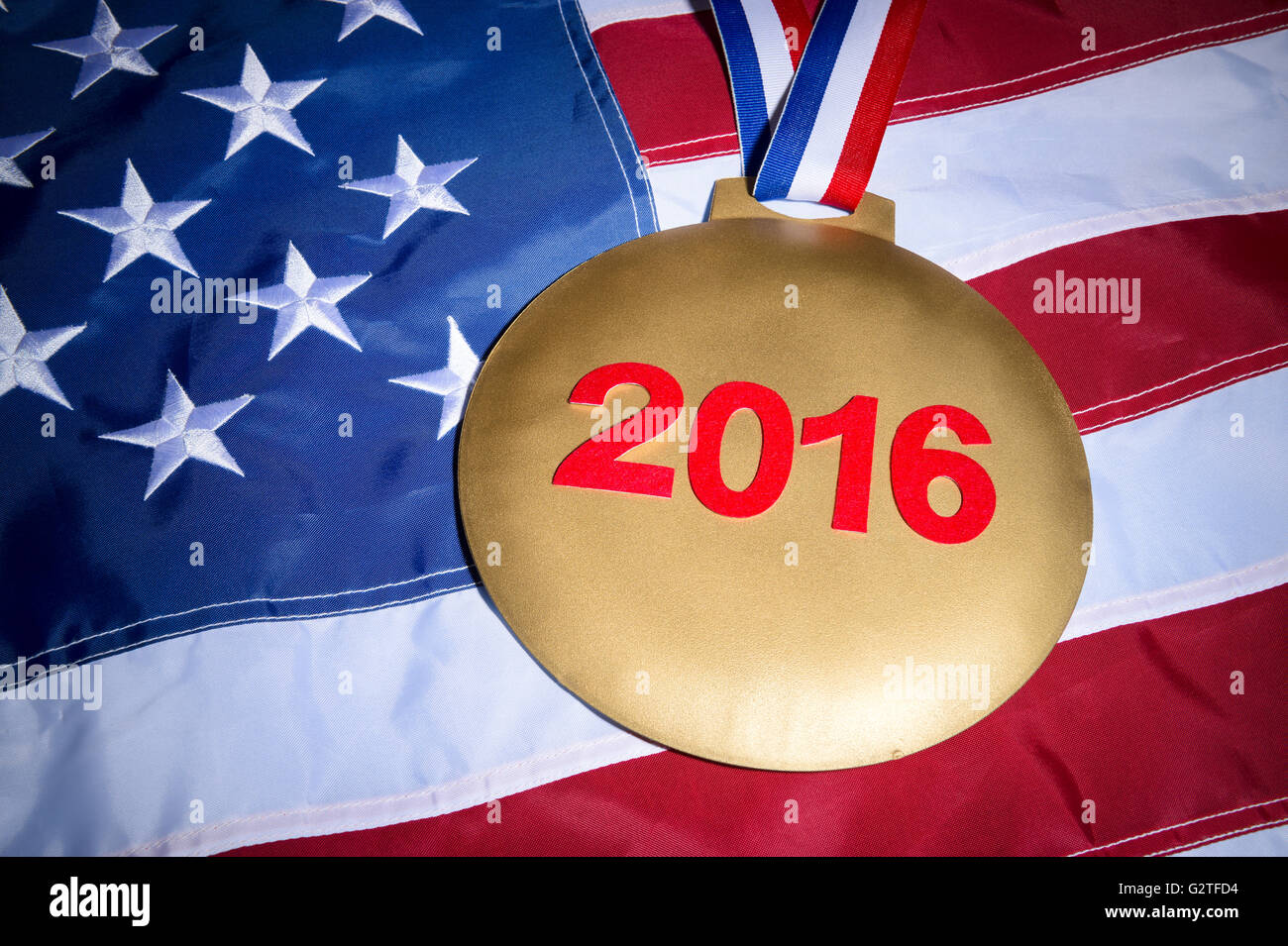 Large 2016 gold medal with USA colors red, white, and blue ribbon on ...