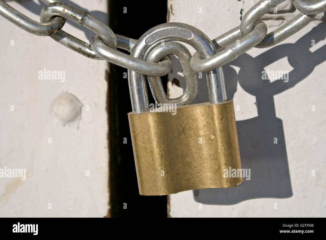 Padlock with chain on old door Stock Photo - Alamy