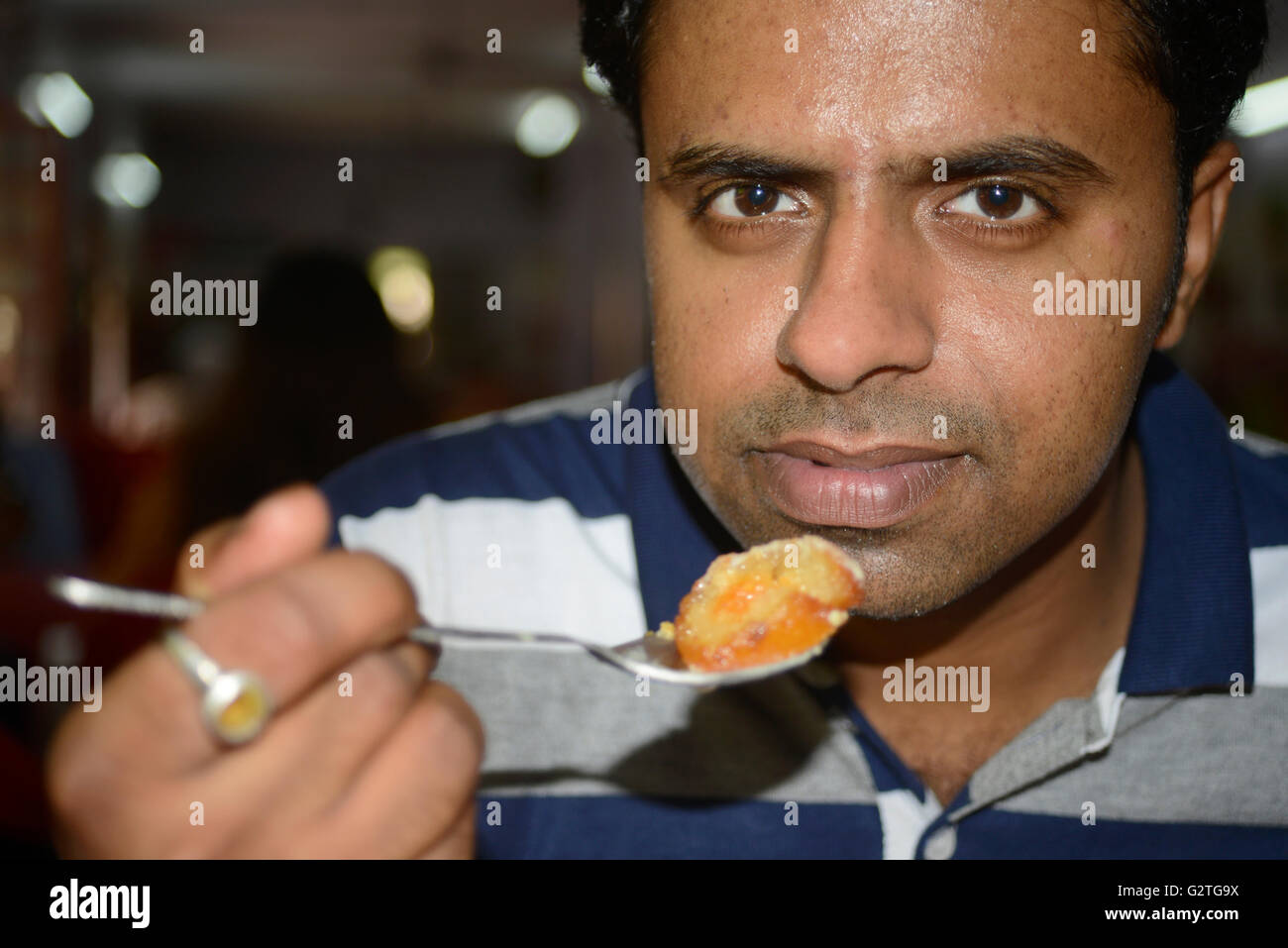 Young Indian male eating food in restaurant,India Stock Photo - Alamy