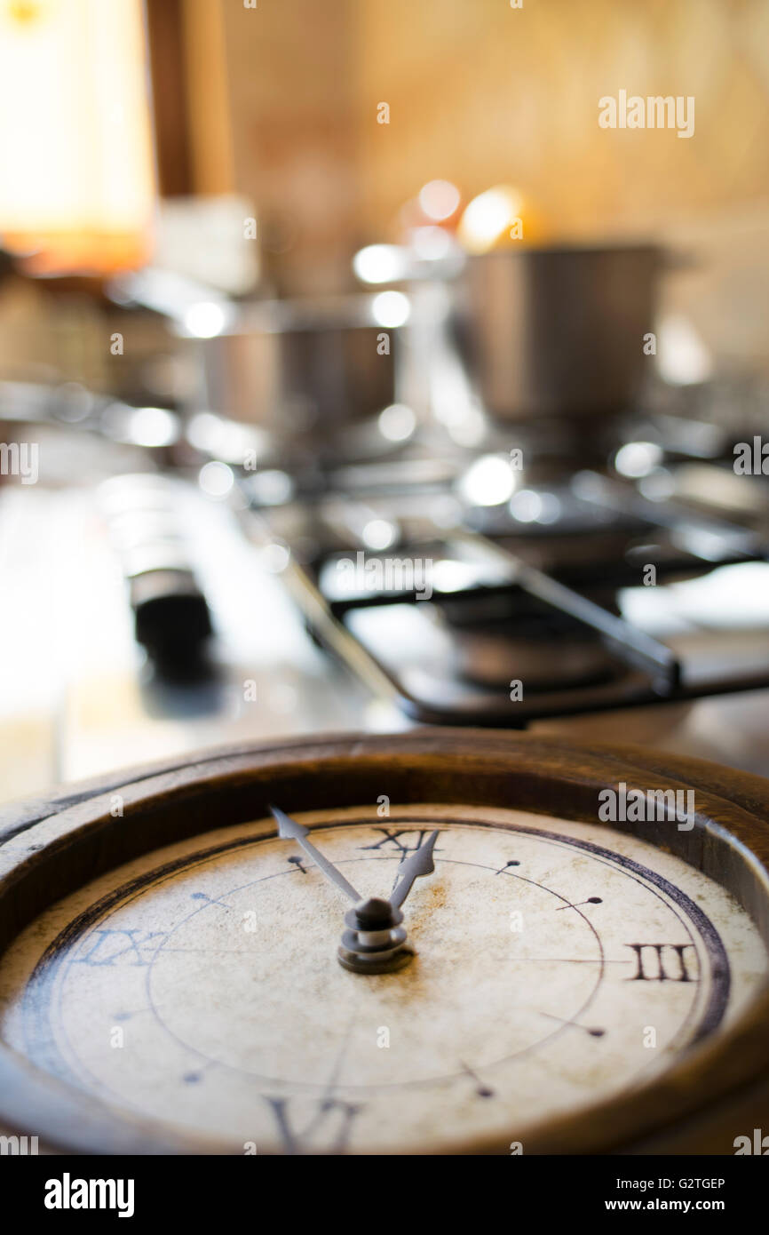 concept of lunch time with an old skeleton clock on a stove-top Stock ...