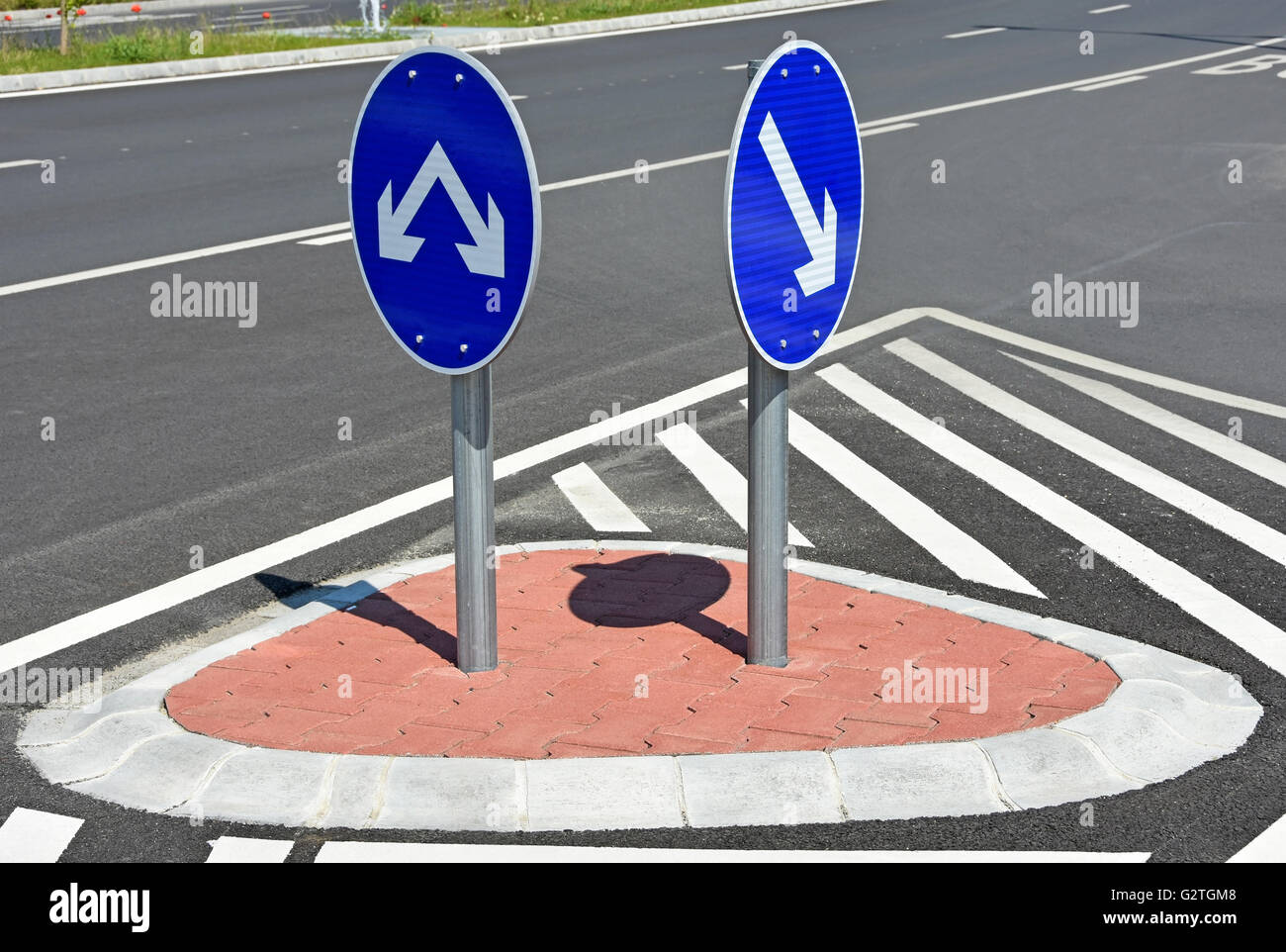 Arrow road signs at the road crossing in the city Stock Photo - Alamy