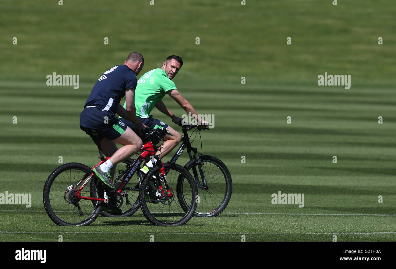 Robbie Keane and physio Tony McCarthy cycle around the pitch during a ...