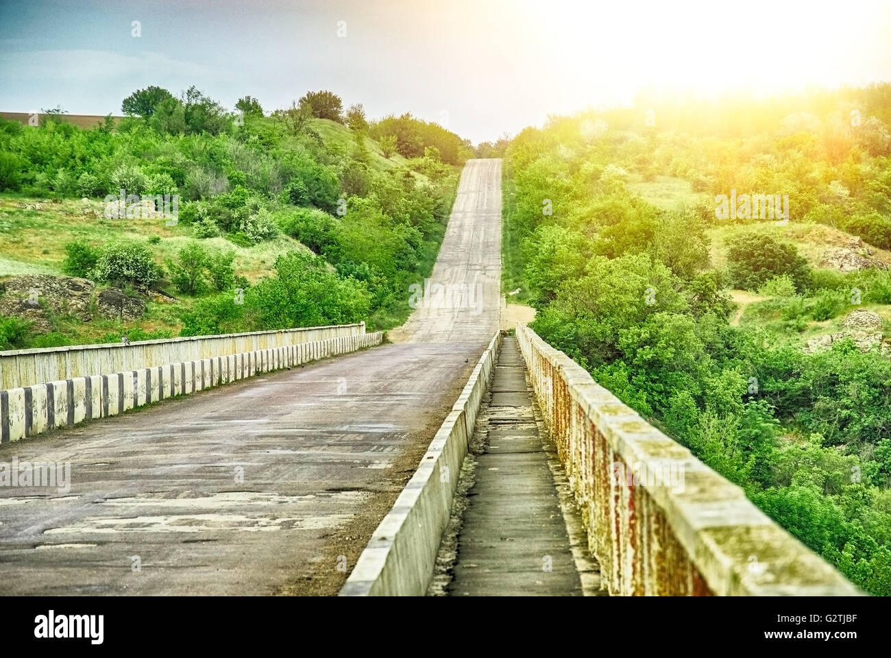 Bridge over the river. Asphalt pavement road with potholes. HDR image ...