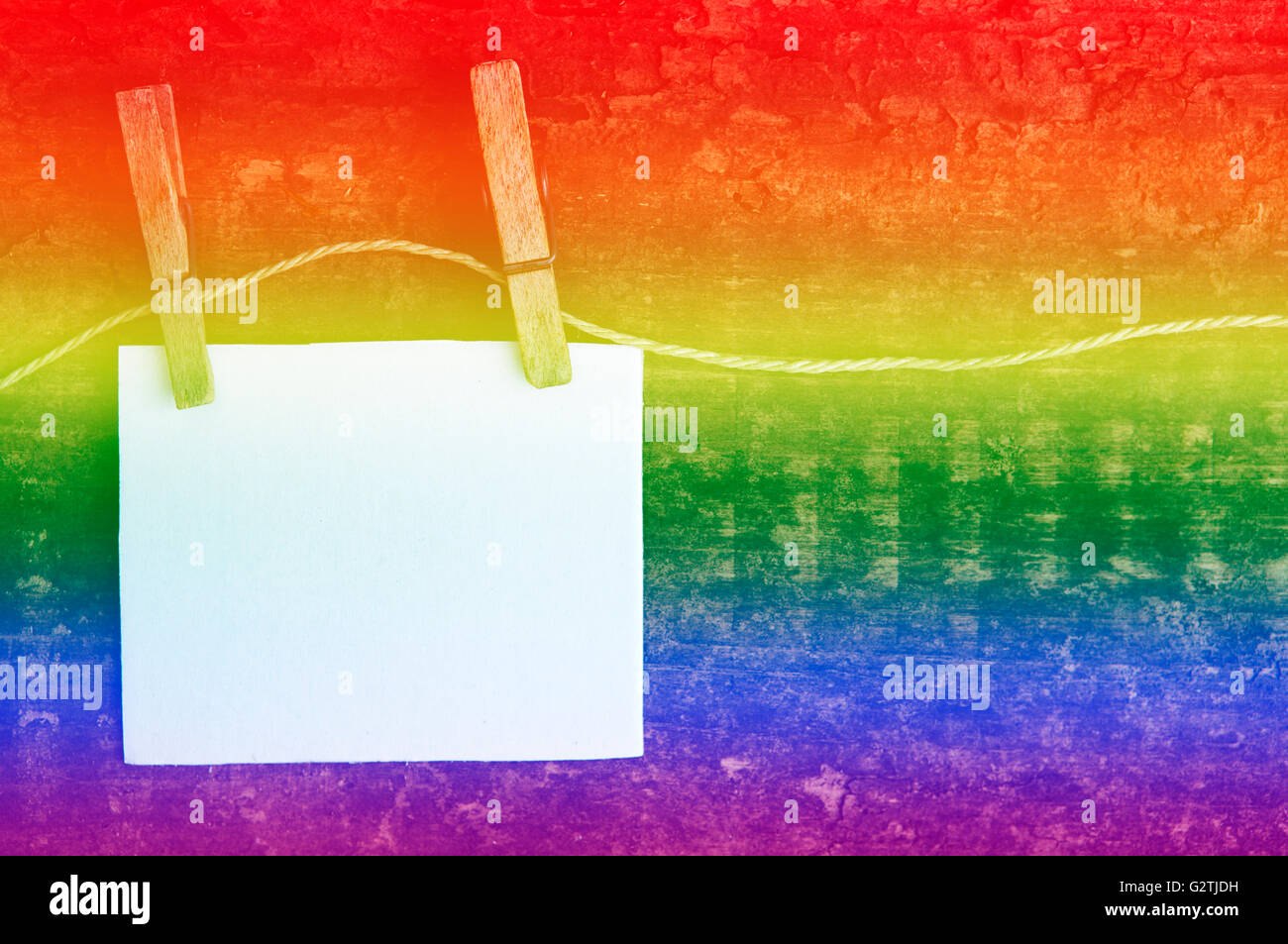 paper sign hanging on clothesline with rainbow colors for gay pride ...