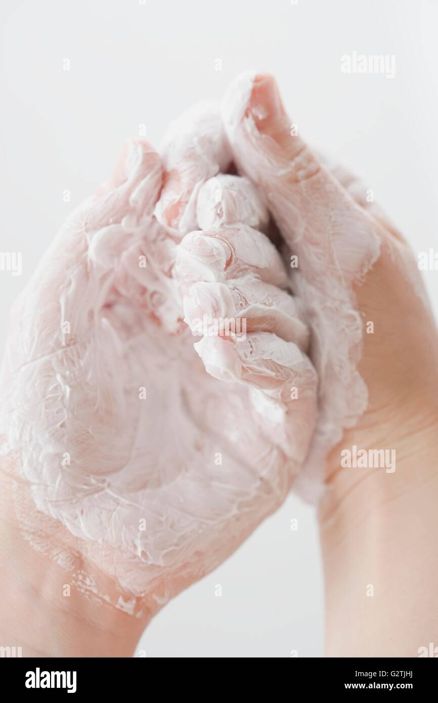 Hands covered in cream Stock Photo - Alamy