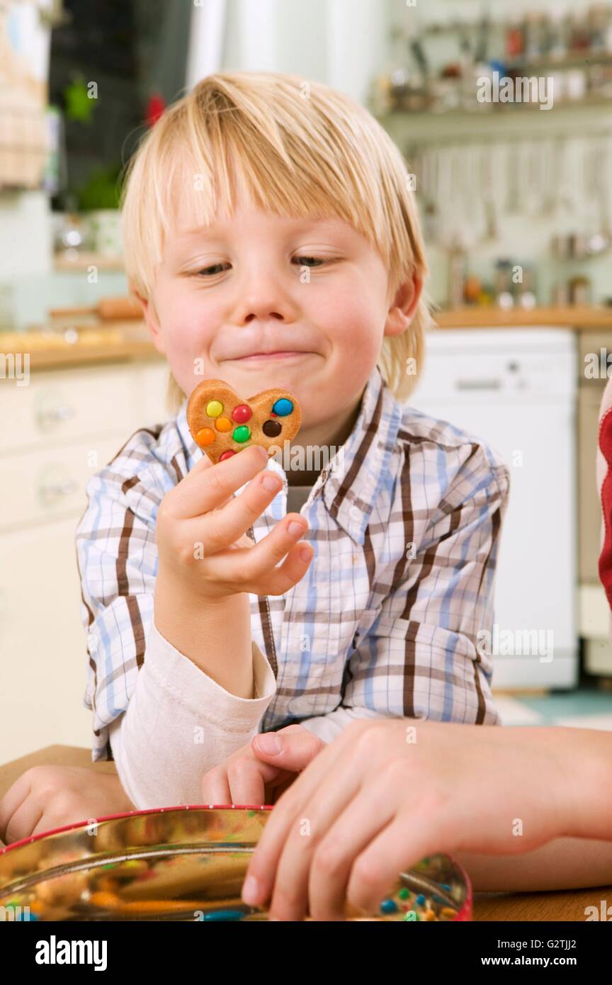 Boy holding a biscuit Stock Photo - Alamy