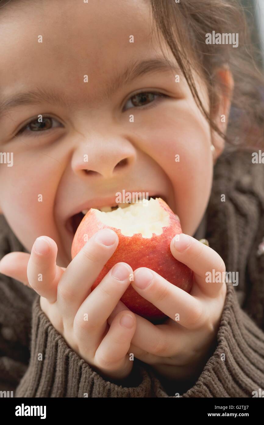 Girl biting into an organic apple Stock Photo - Alamy