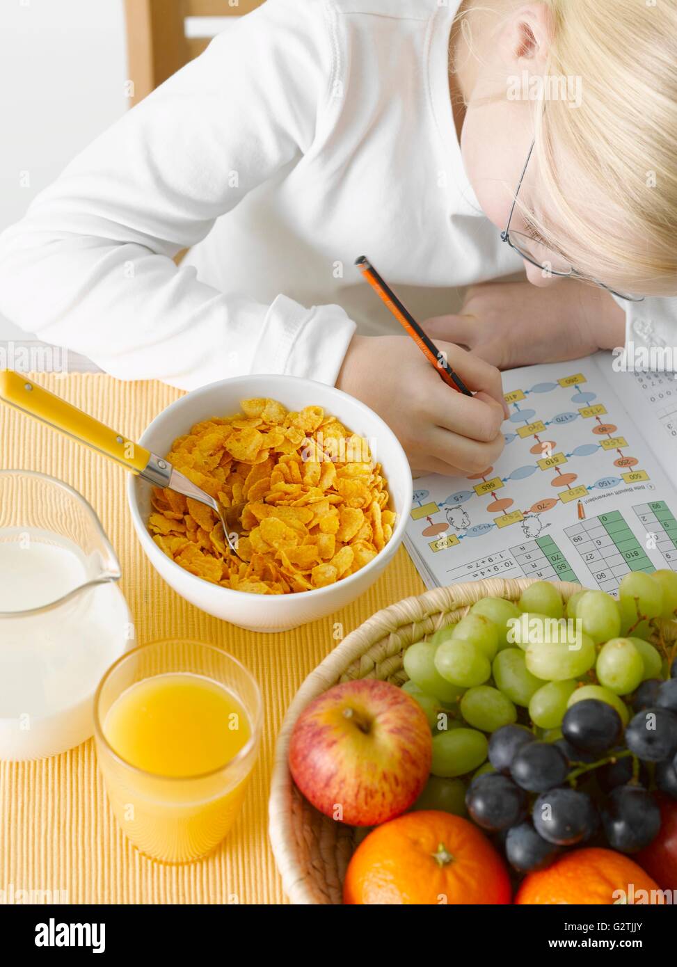 Girl with exercise book in front of healthy breakfast Stock Photo - Alamy