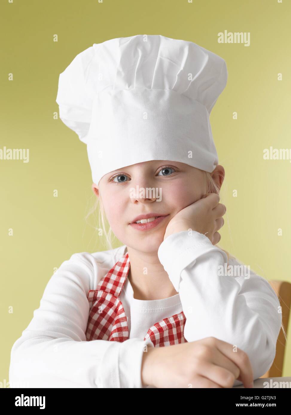 Girl in chef's hat and apron Stock Photo - Alamy