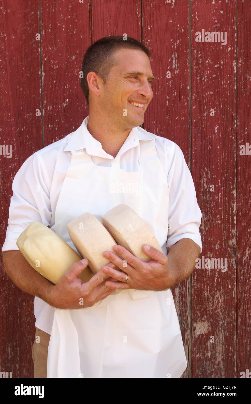 Cheese Maker in Apron Holding Goat Cheese Rounds Stock Photo - Alamy