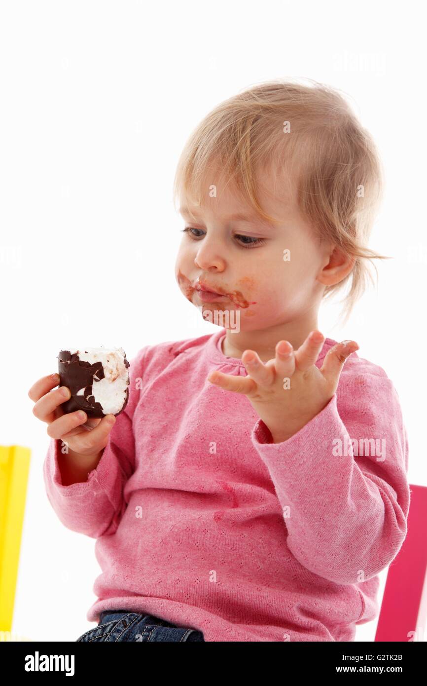 A small child eating a chocolate marshmallow Stock Photo - Alamy