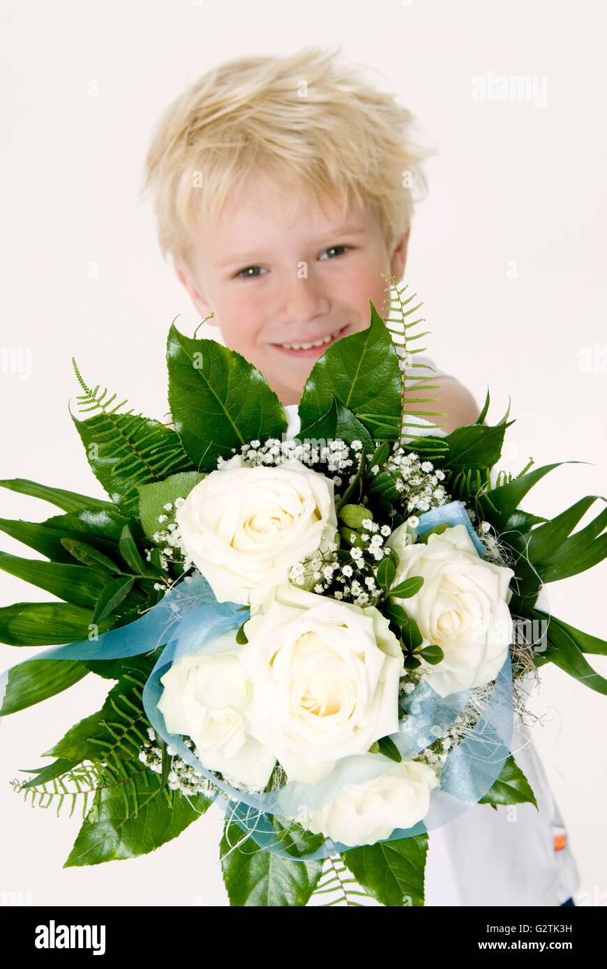 Blond boy with bouquet of white roses Stock Photo - Alamy