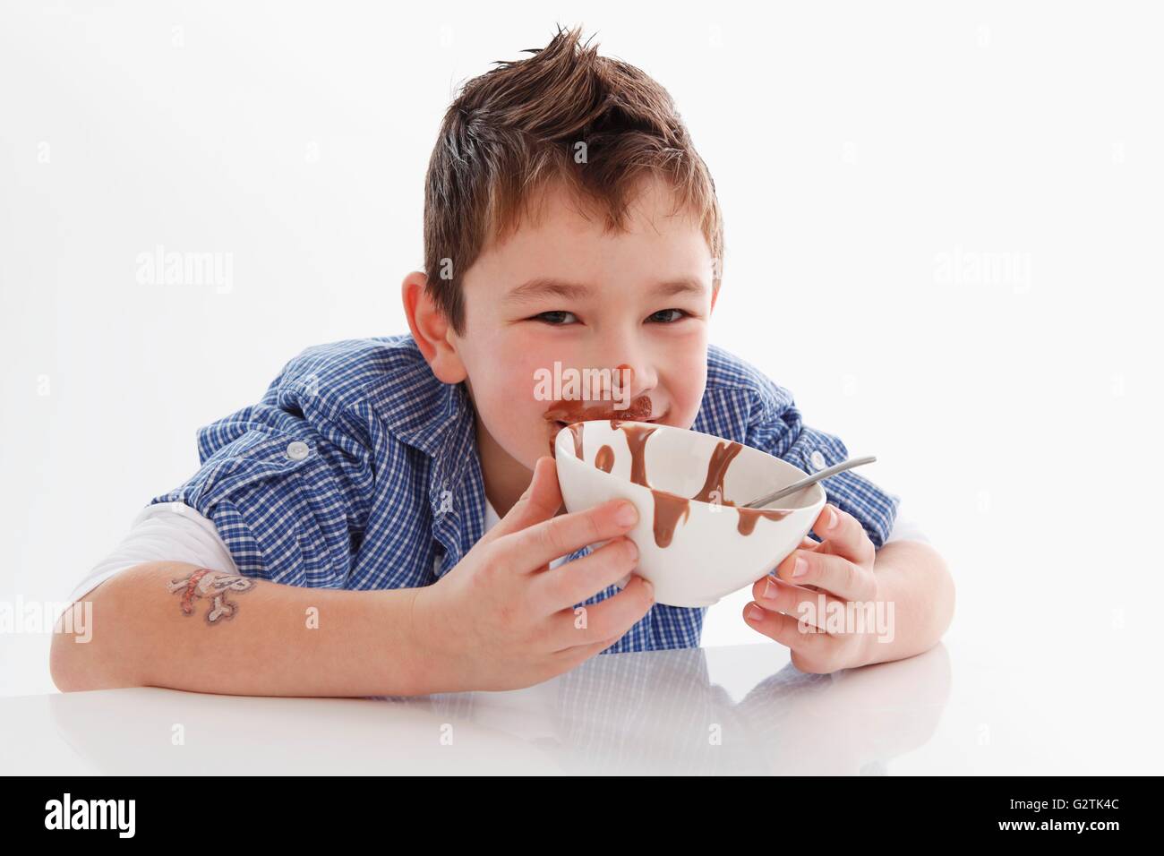 Small boy eating chocolate pudding Stock Photo - Alamy