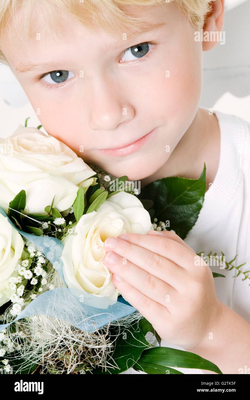 Boy with bouquet of white roses Stock Photo - Alamy