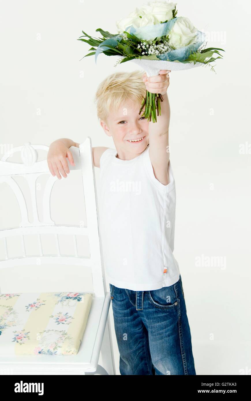 Blond boy with bouquet of white roses Stock Photo - Alamy