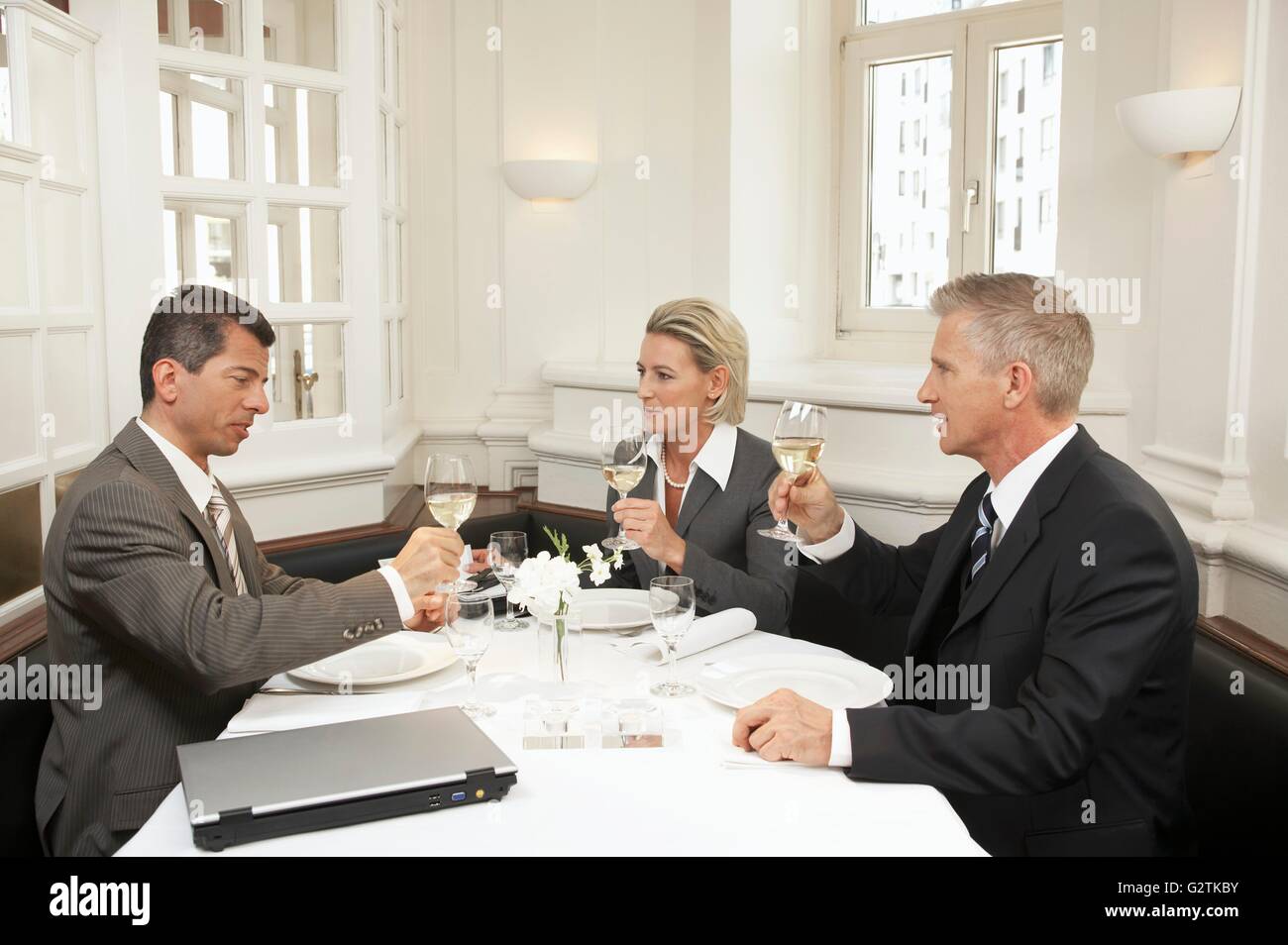 Three business people eating a meal together Stock Photo - Alamy
