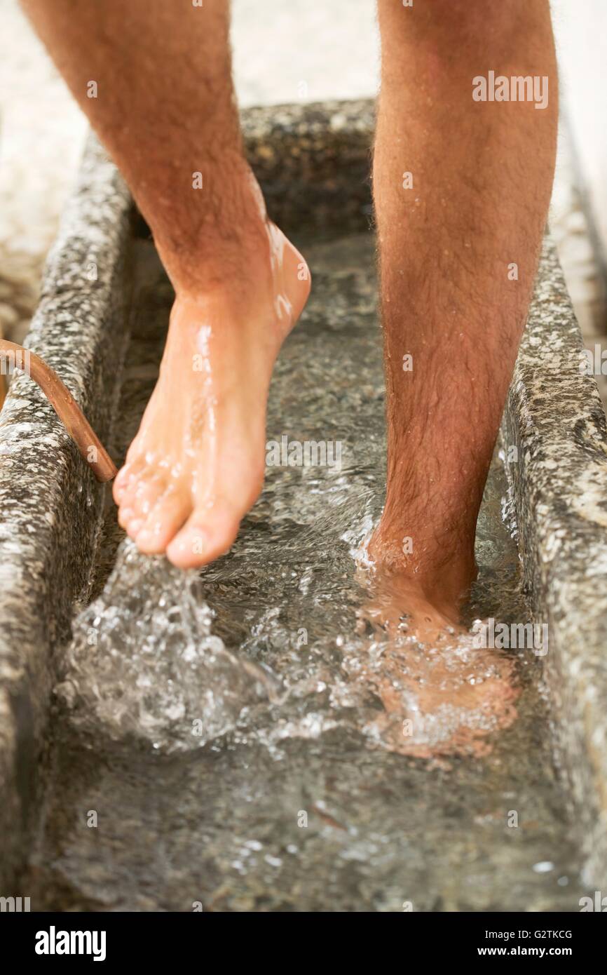 Man walking in wading pool (close-up Stock Photo - Alamy