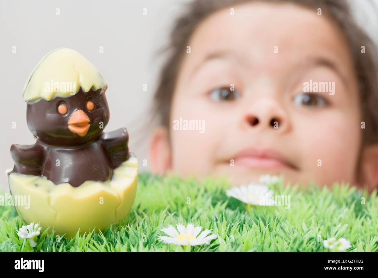 A girl with a chocolate chick hatching out of an egg Stock Photo - Alamy