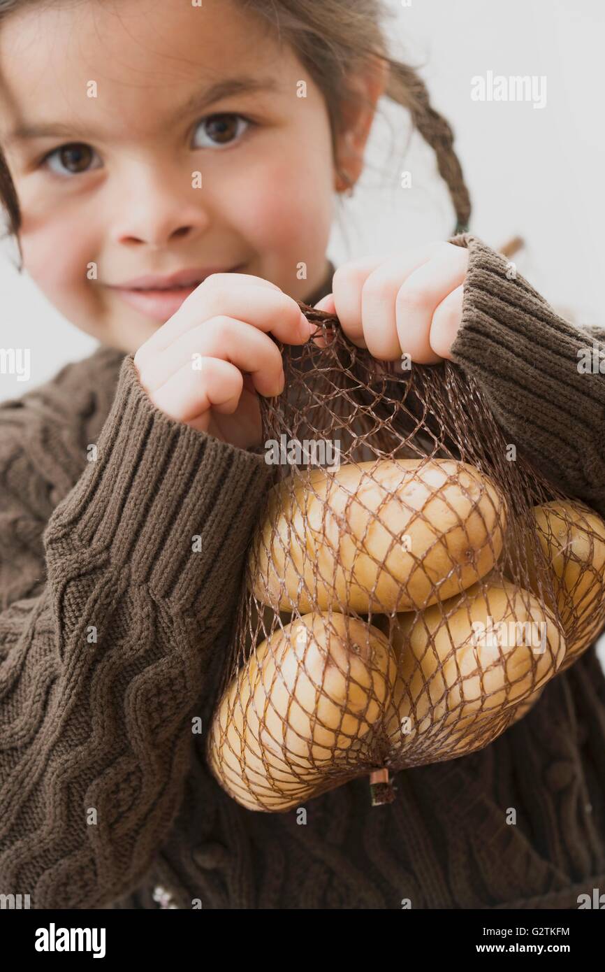 Girl with a bag of potatoes Stock Photo - Alamy