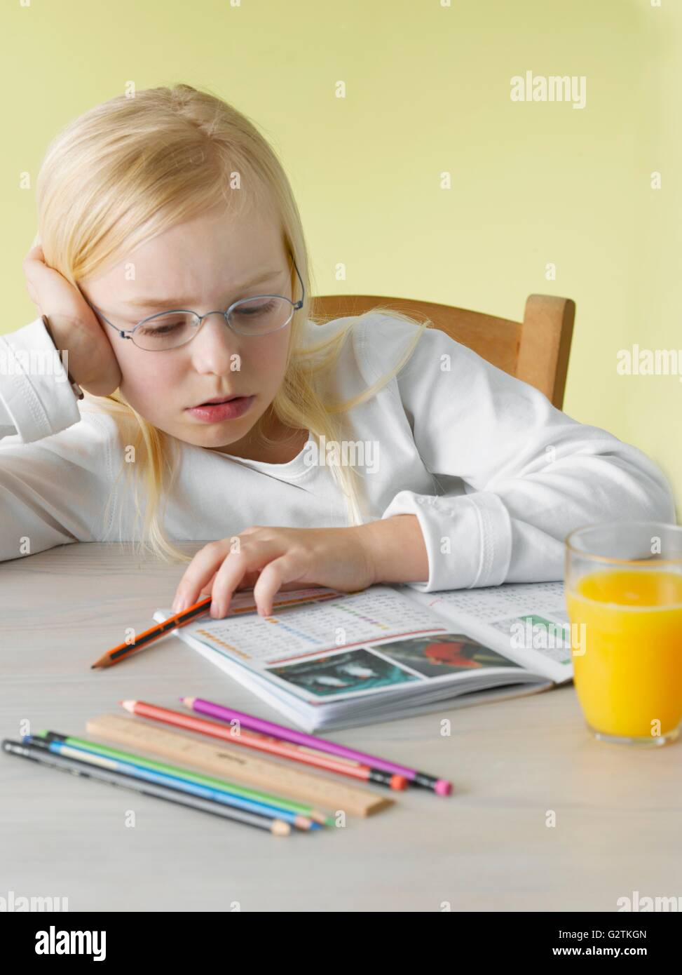 Bored girl reading a school book Stock Photo - Alamy