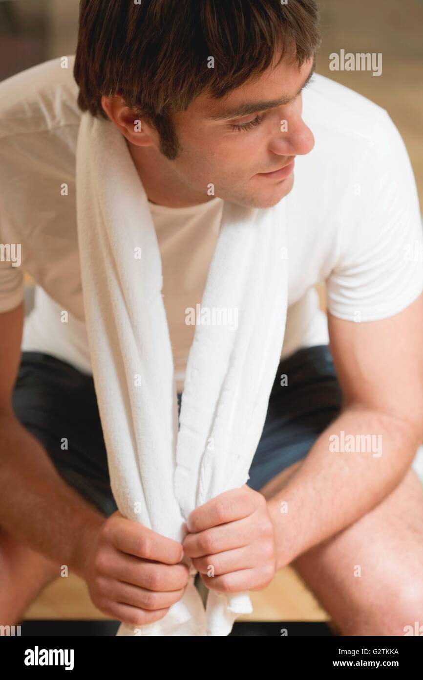 Young man with towel after workout Stock Photo - Alamy