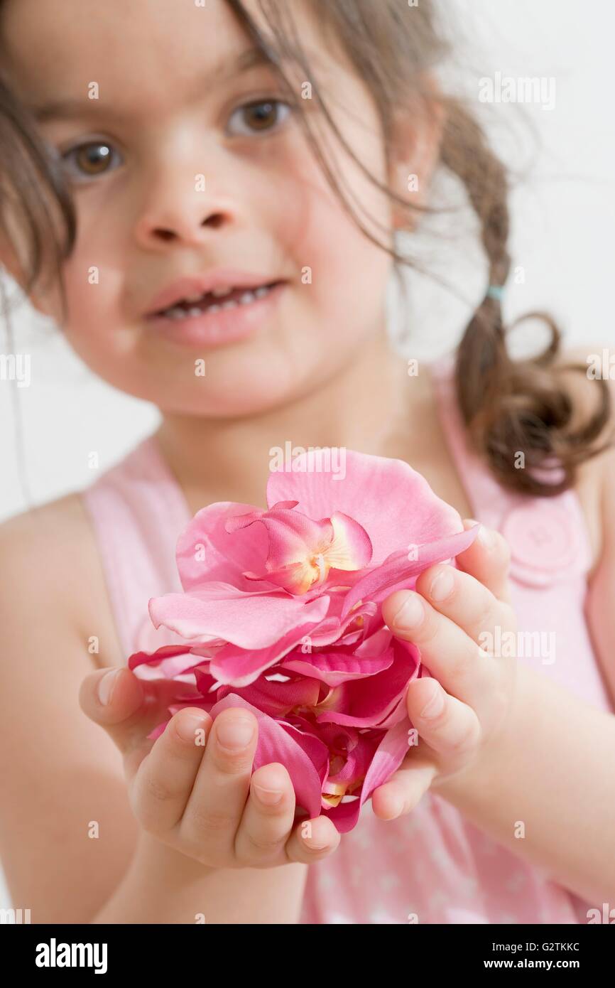 Girl holding rose petals Stock Photo - Alamy