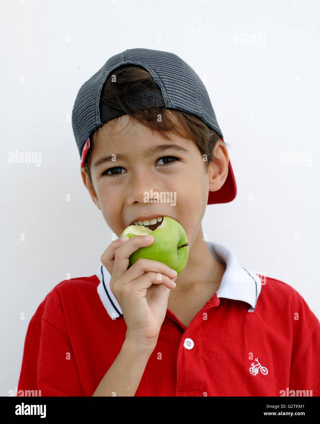 Boy biting into an apple Stock Photo - Alamy