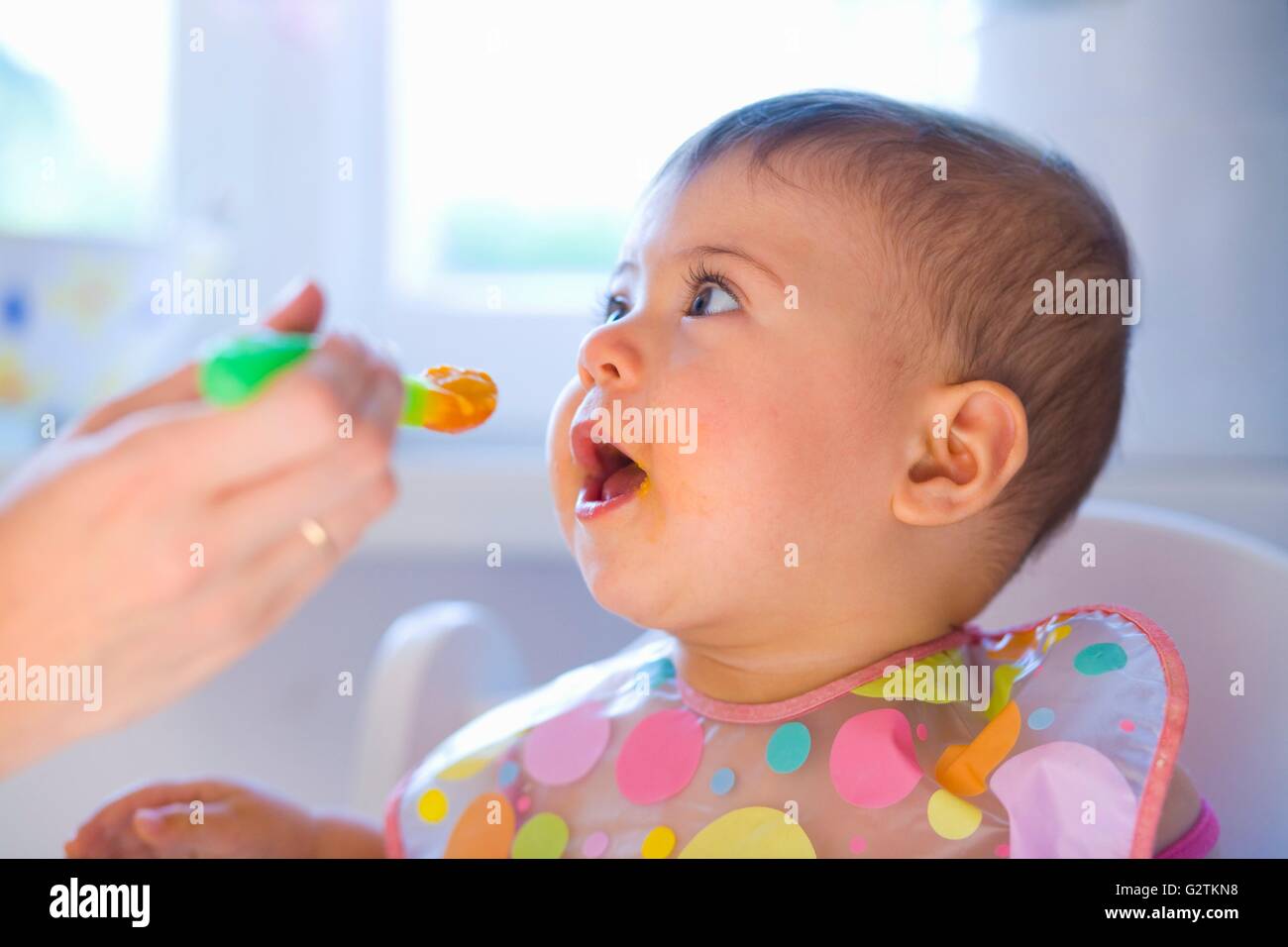 Baby being fed baby food Stock Photo - Alamy